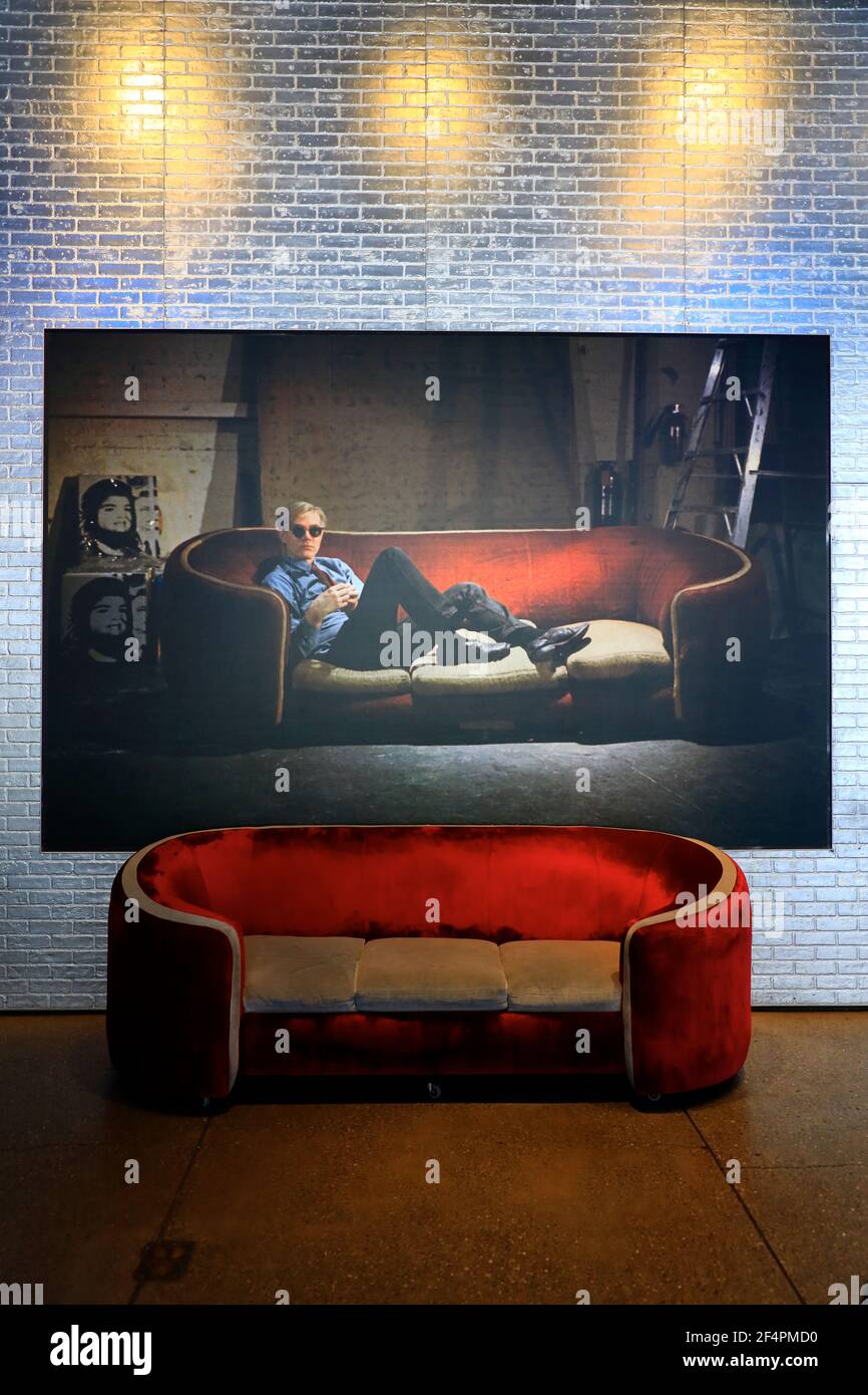 A Photo Of Andy Warhol In A Red Couch Display Above A Red Couch In The Cafe Of The Andy Warhol