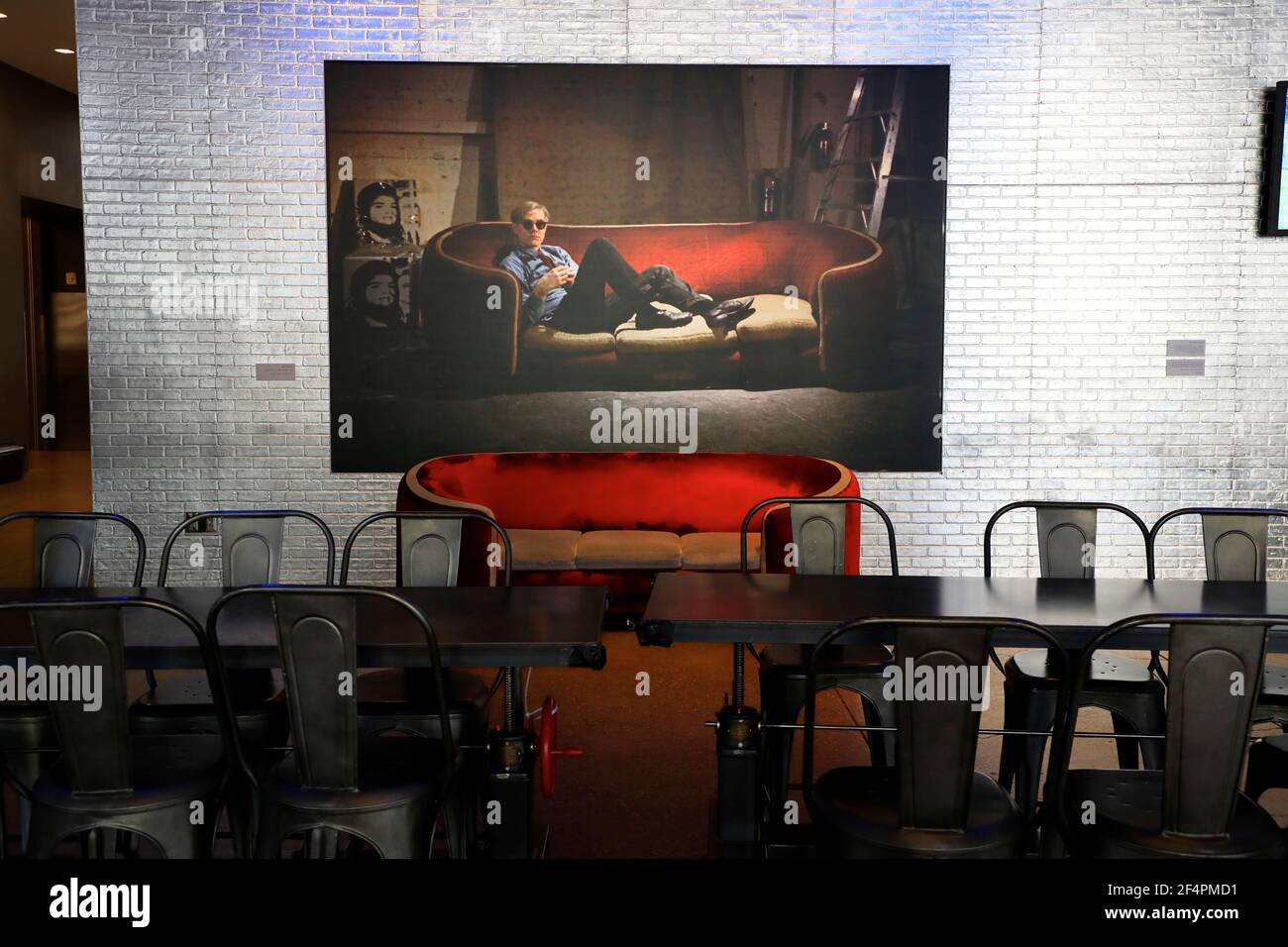A Photo Of Andy Warhol In A Red Couch Display Above A Red Couch In The Cafe Of The Andy Warhol