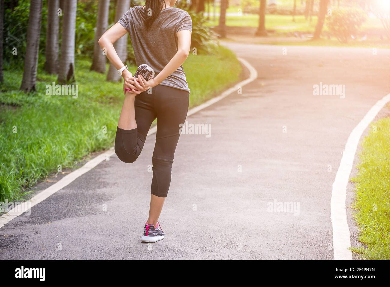 Young woman is running exercising outdoors in sunny nature at the park ...