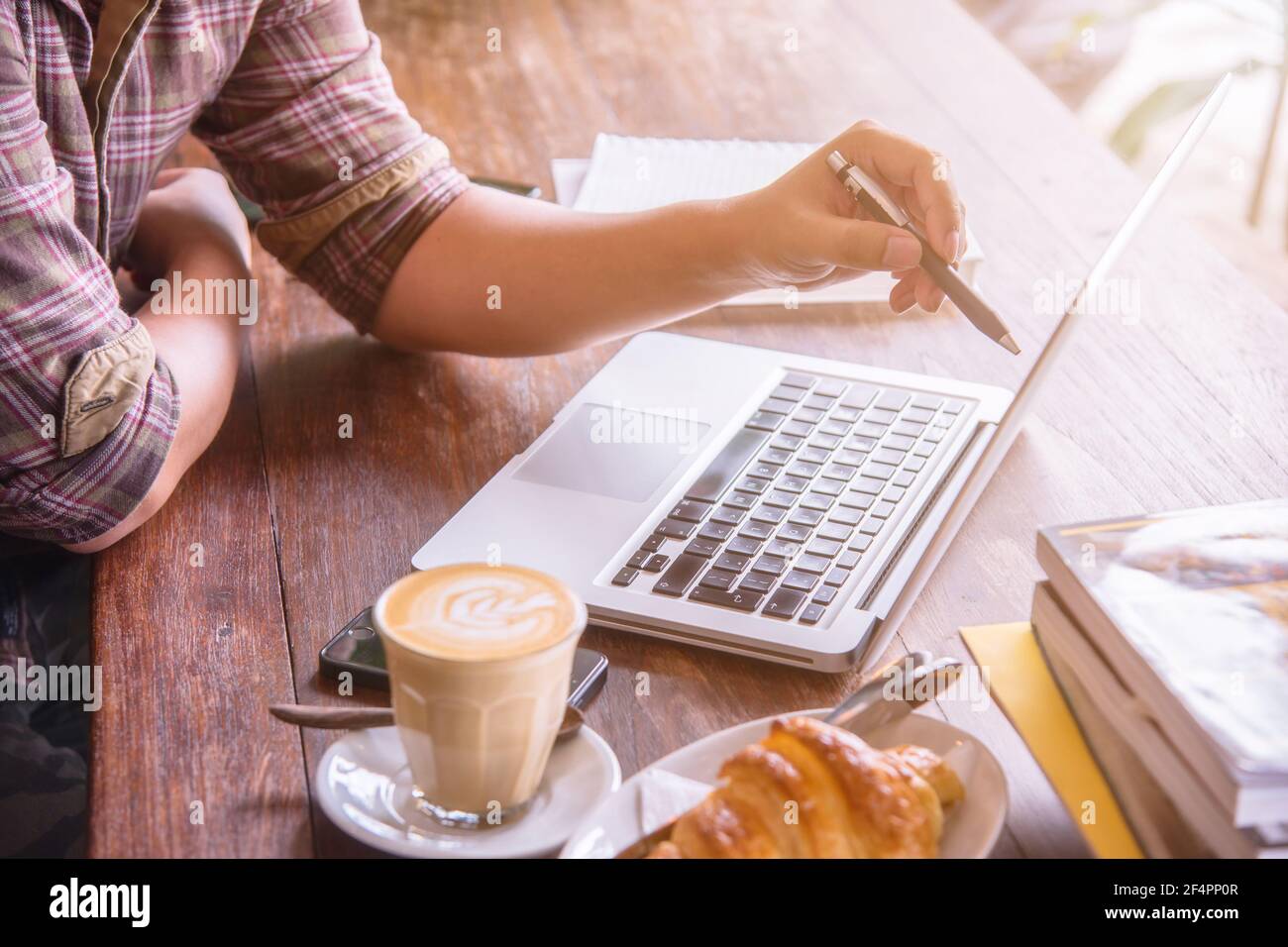 A business man using laptop computer with cup coffee and bread on the ...