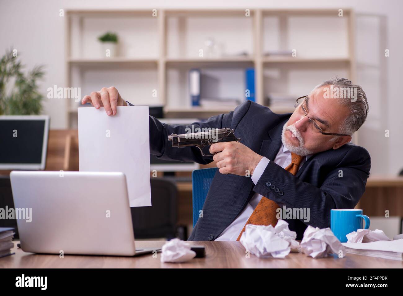 Old employee in paper recycling concept Stock Photo - Alamy