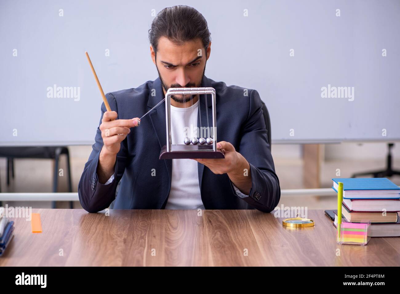 Young teacher physicist in the classroom Stock Photo - Alamy