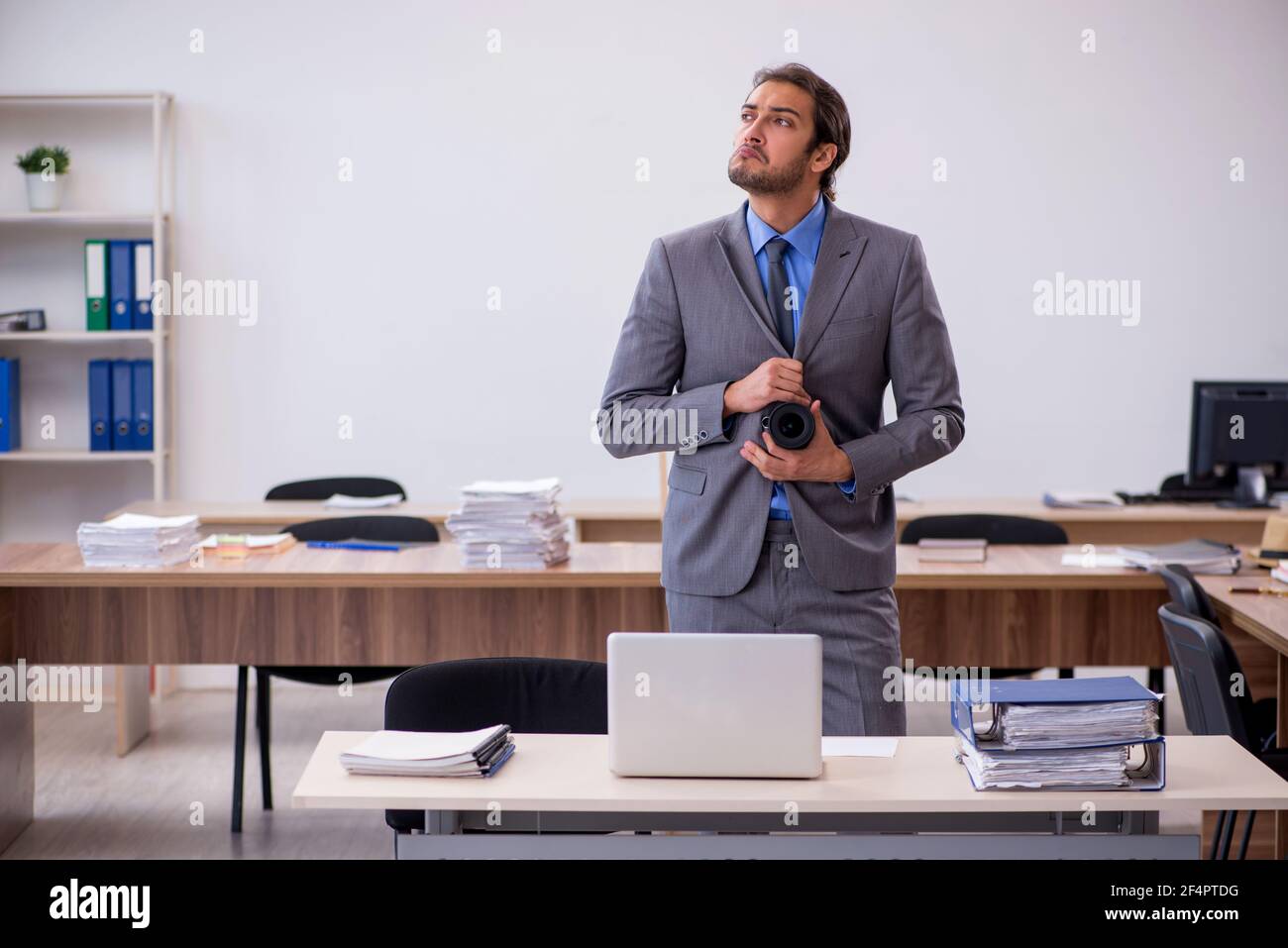 Young employee in industrial espionage concept Stock Photo - Alamy