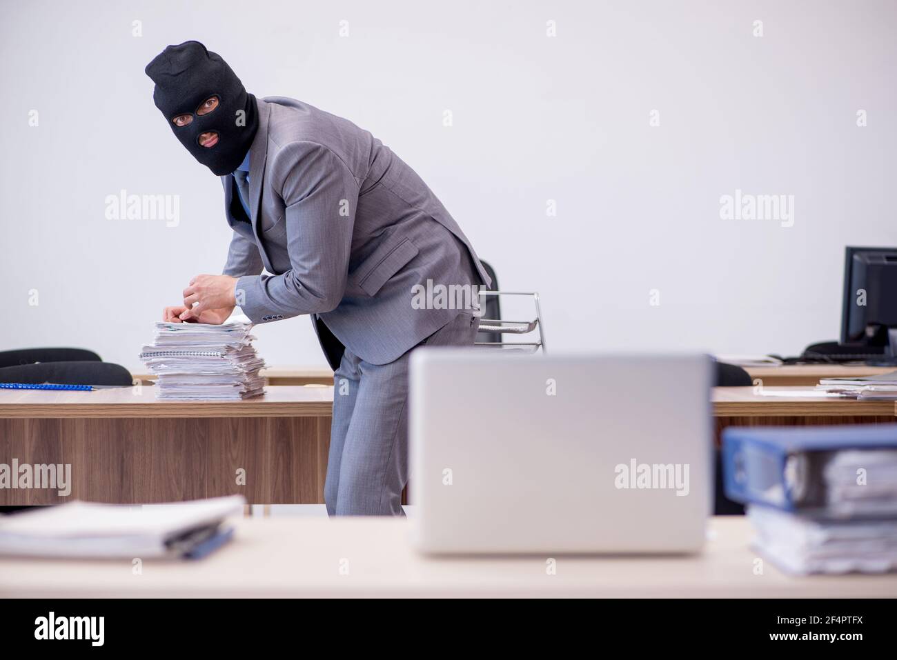 Young employee in industrial espionage concept Stock Photo - Alamy