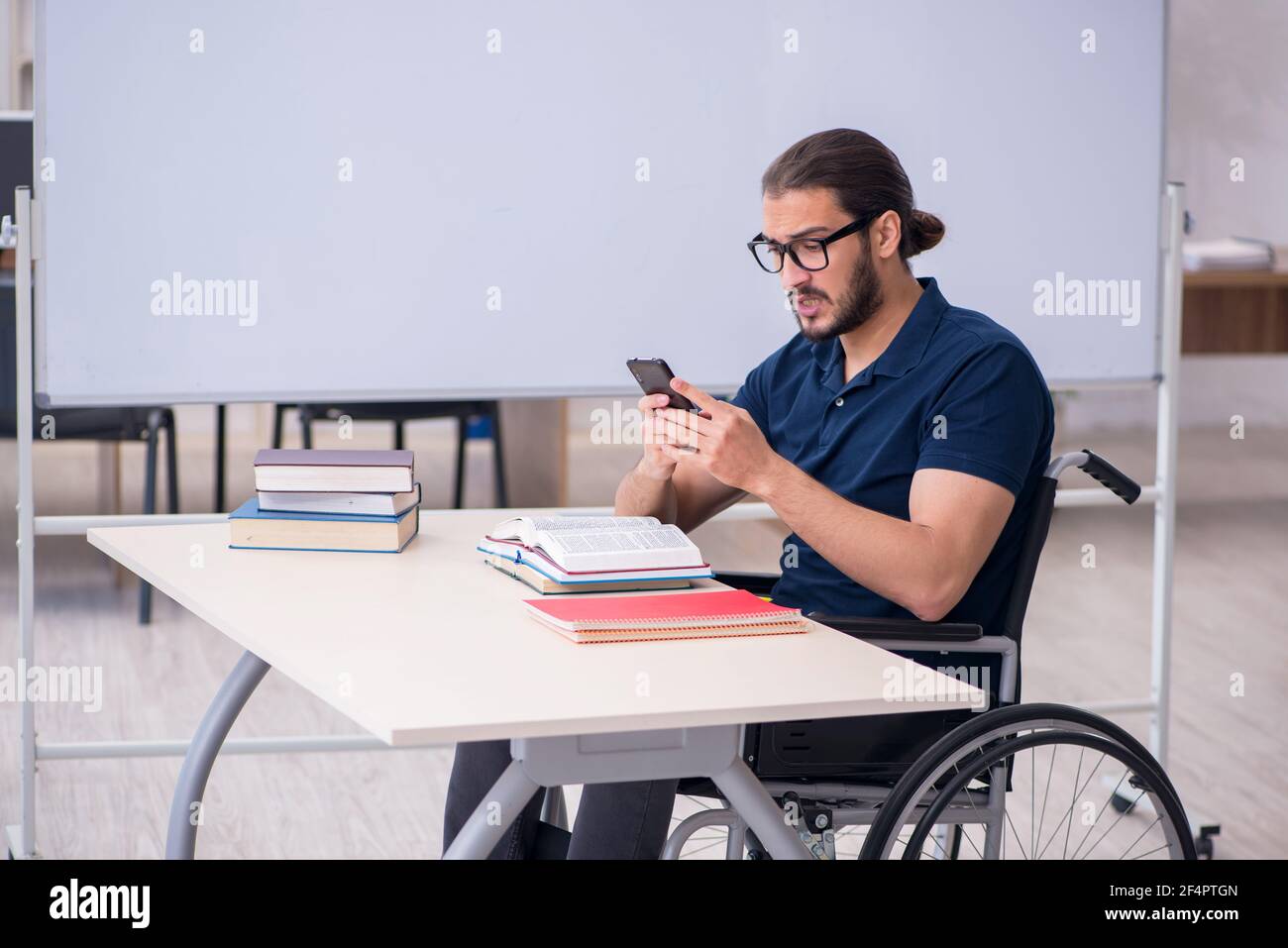Young handicapped student in the classroom Stock Photo - Alamy