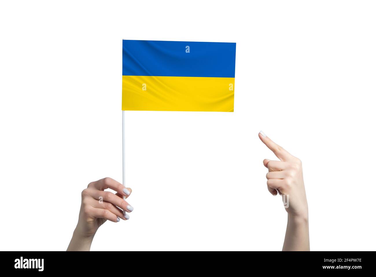 A beautiful female hand holds a Ukraine flag to which she shows the ...
