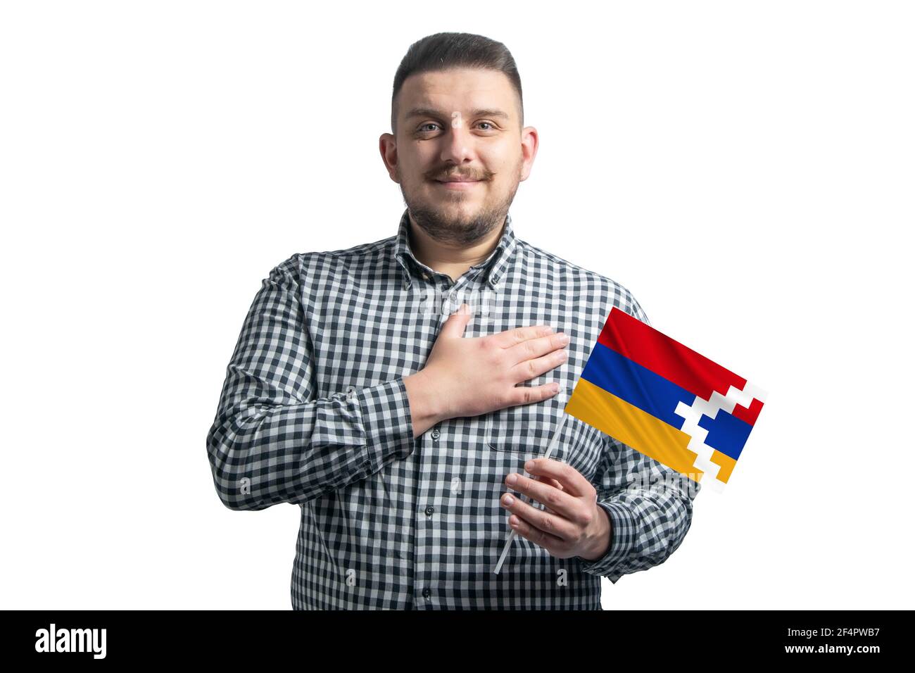 White guy holding a flag of Nagorno-Karabakh Republic and holds his hand on his heart isolated ...