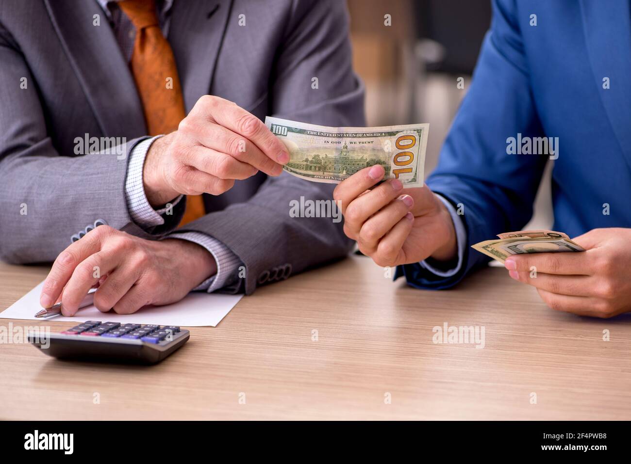 Two employees in remuneration concept Stock Photo - Alamy