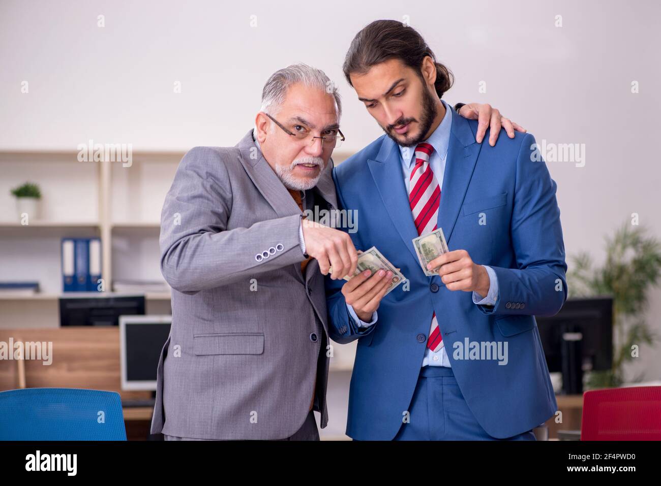 Two employees in remuneration concept Stock Photo - Alamy