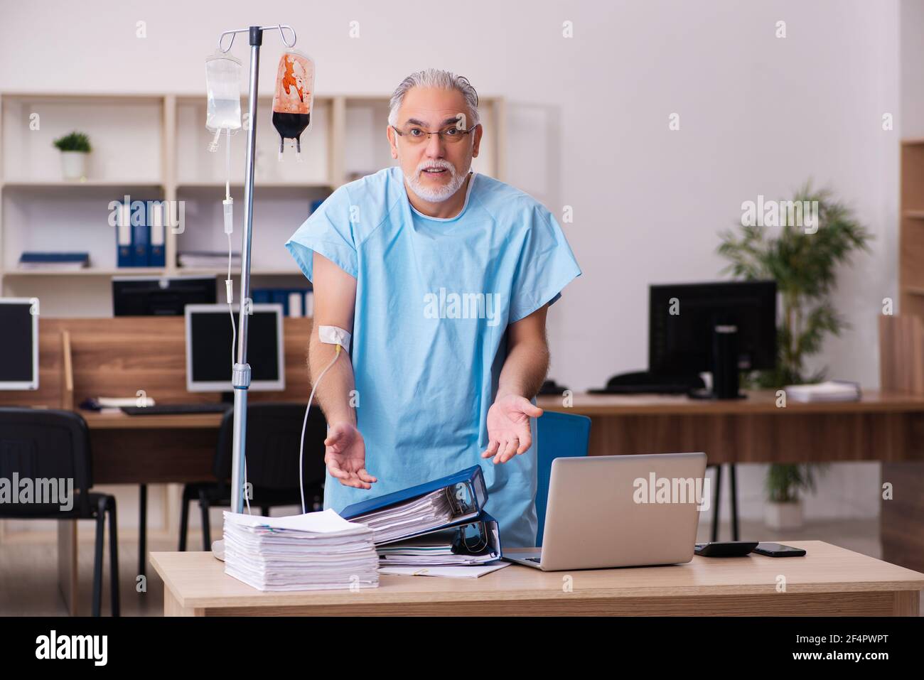 Old businessman employee in blood transfusion concept Stock Photo - Alamy