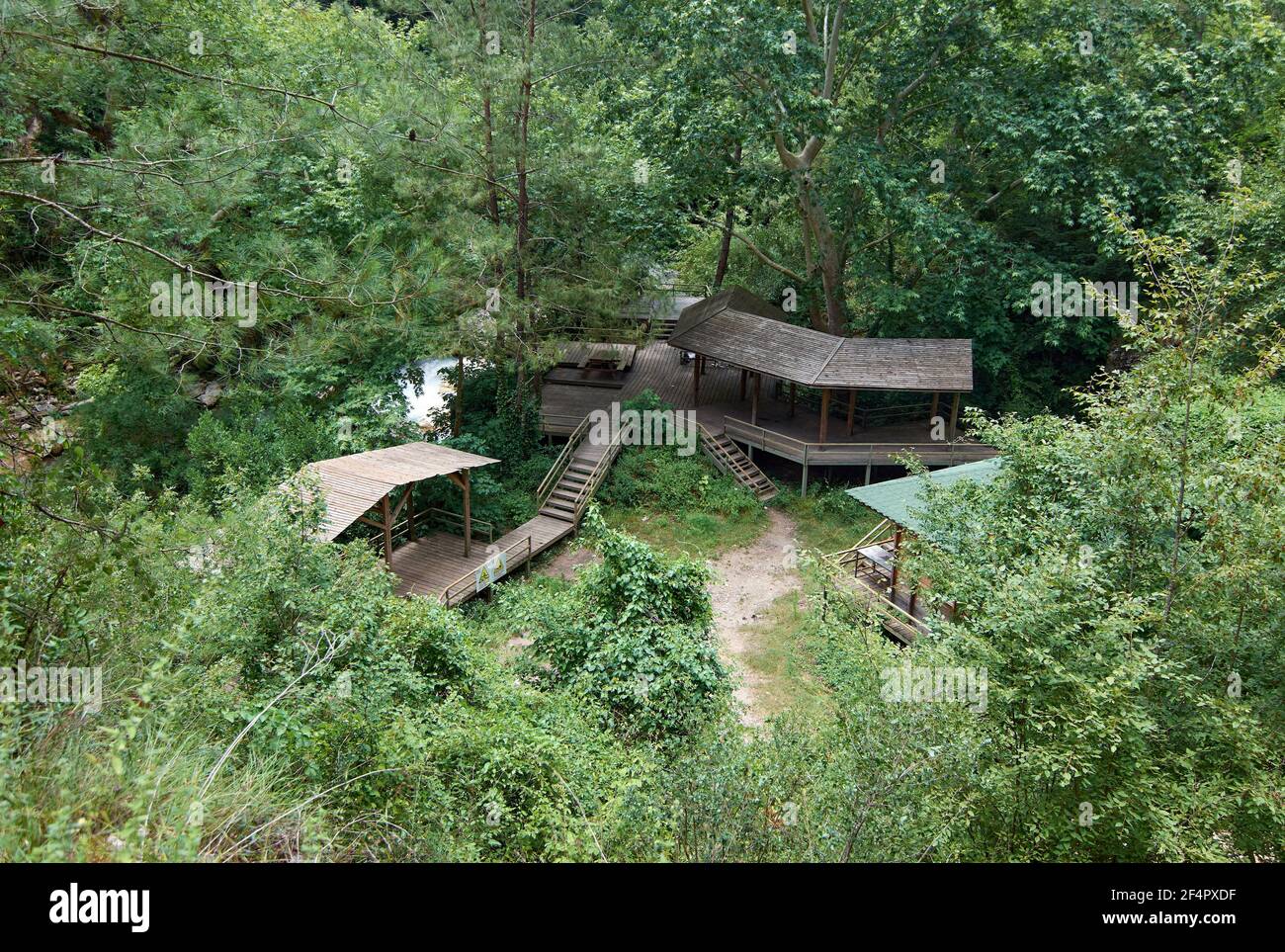 Aerial view of a wooden deck in a mountain resort surrounded by trees ...