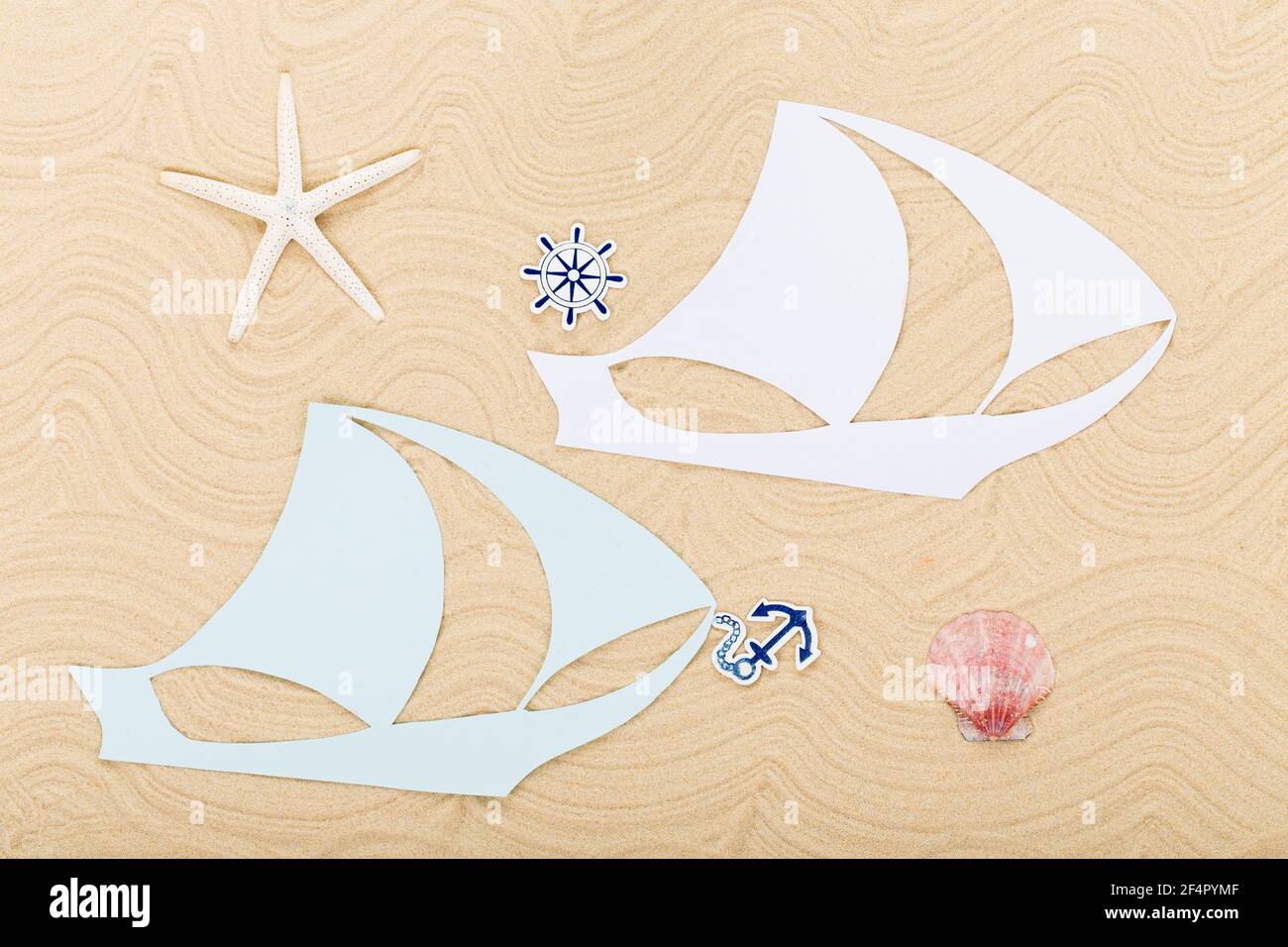 Paper clipper boats on waved sand. Photo can be used as a whole ...