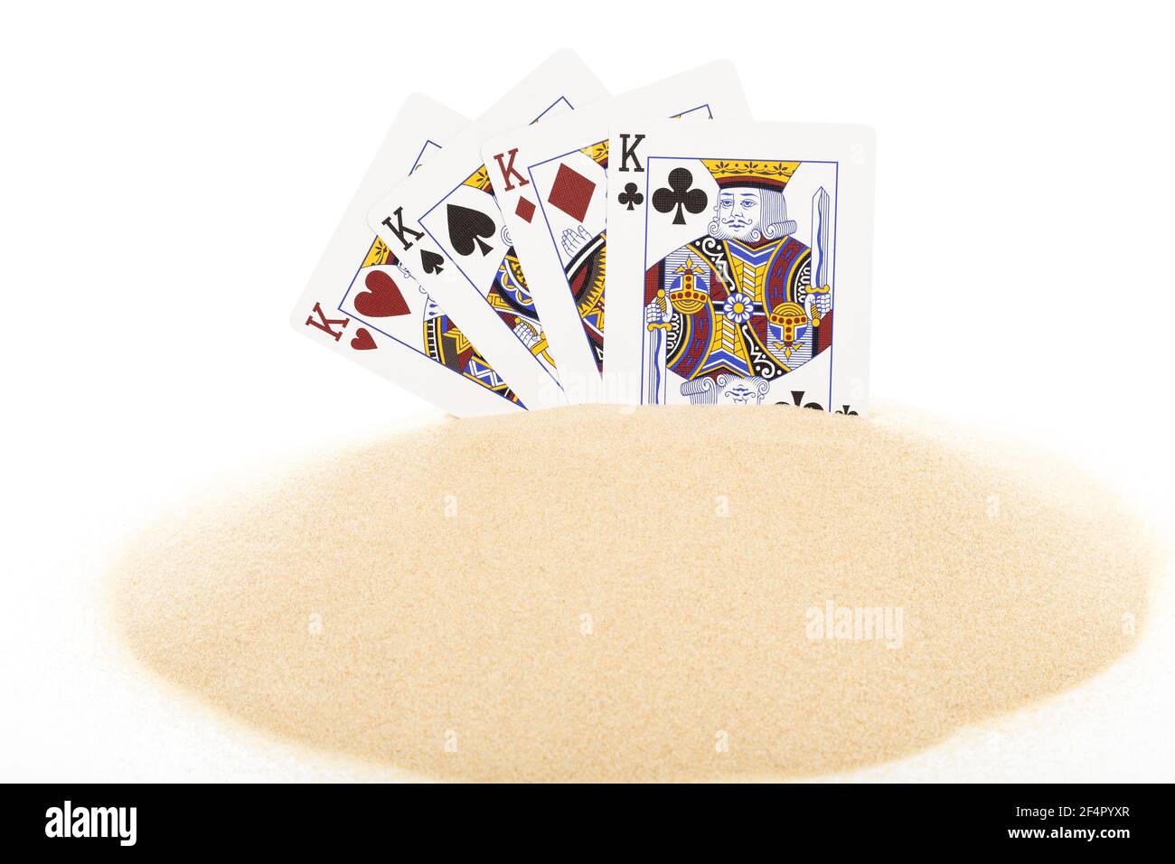 Playing cards on heap of sand as a concept. Isolated on a white ...