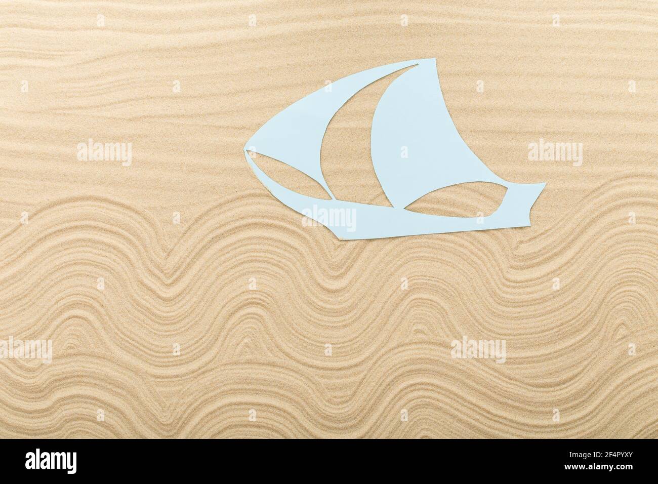 Paper clipper boat on waved sand. Photo can be used as a whole ...