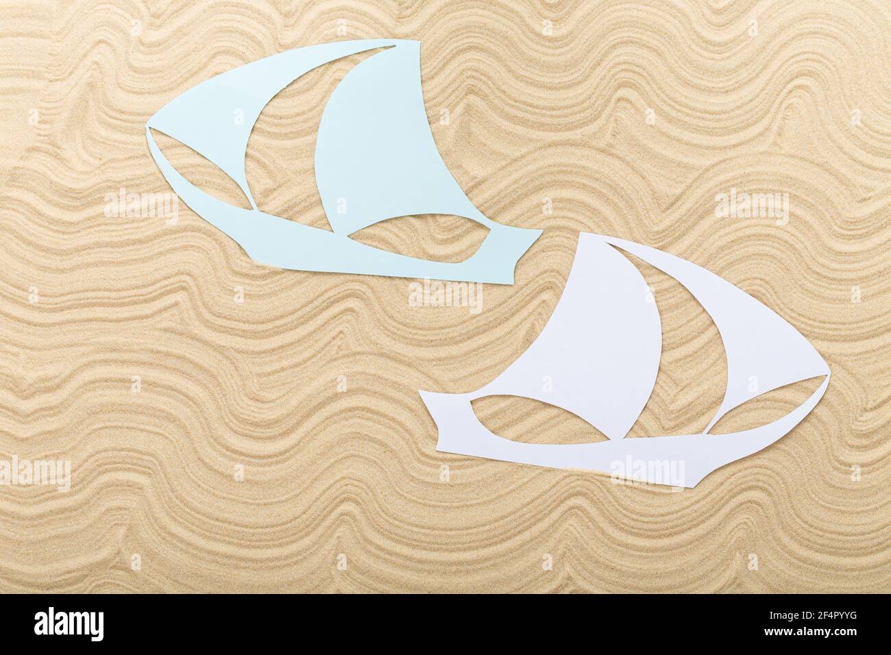 Yellow paper boat on sand hi-res stock photography and images - Alamy