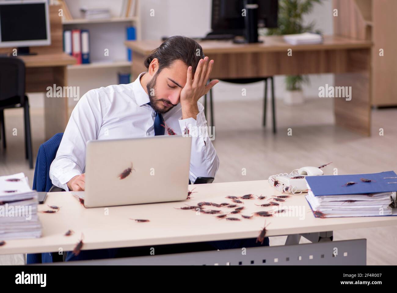 Young businessman employee and too many cockroaches in the office Stock ...