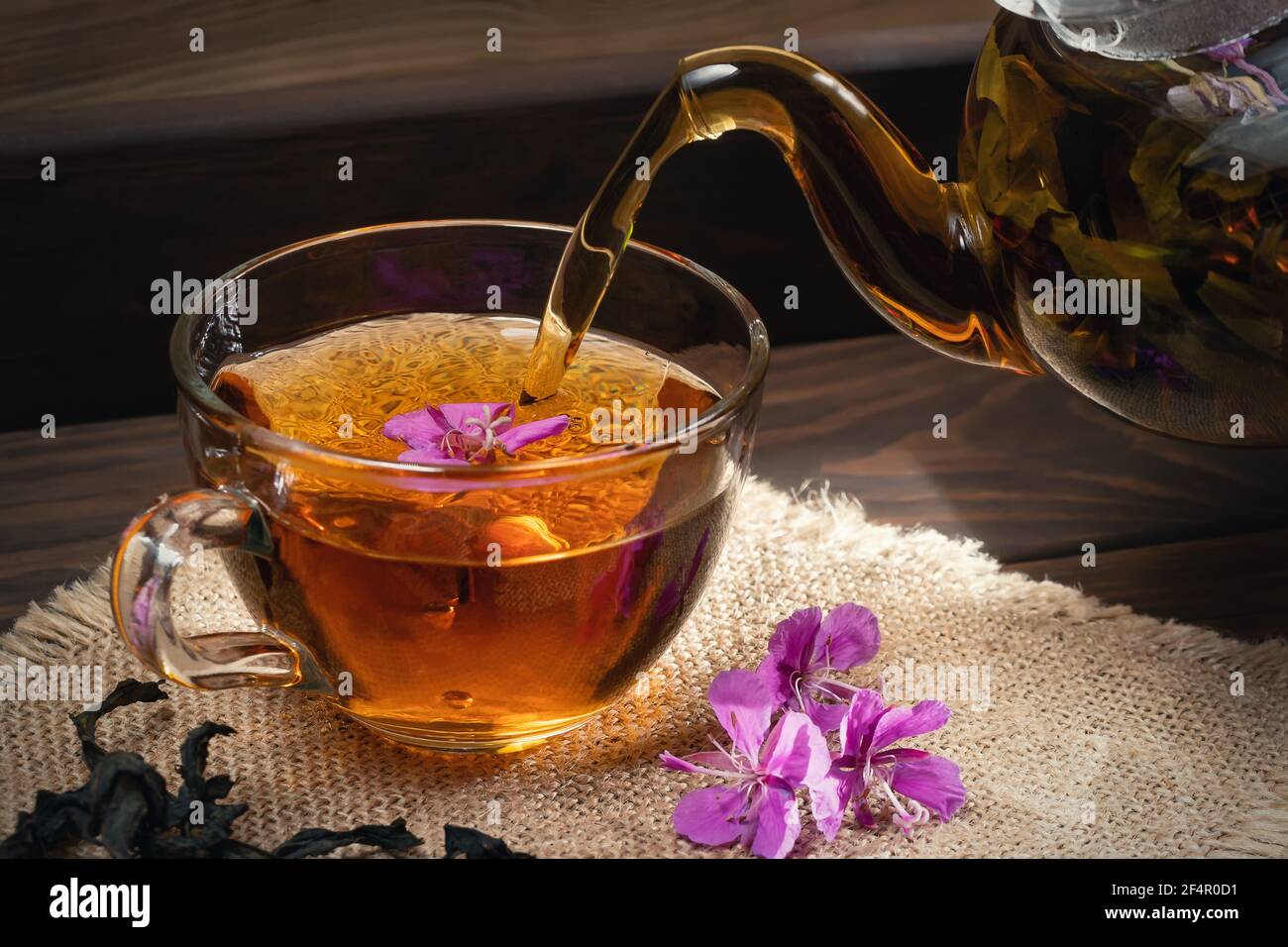Pouring fireweed herbal tea into a transparent cup Stock Photo - Alamy