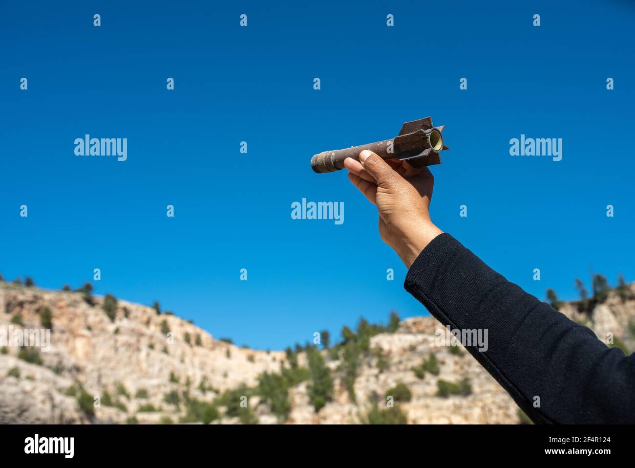 Mortar weapon bomb in man hands on nature background Stock Photo - Alamy