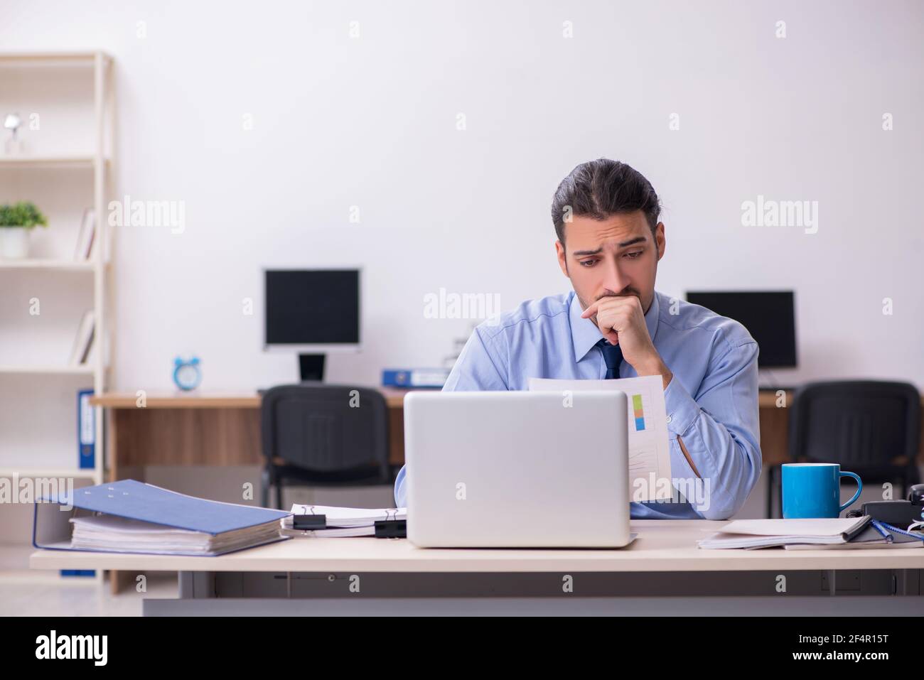 Sick male employee suffering at the workplace Stock Photo - Alamy
