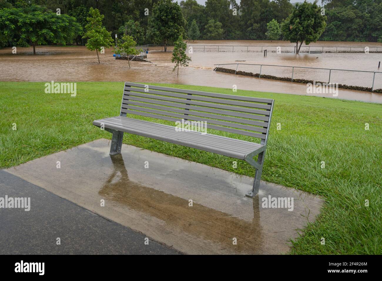 A park bench remains above the flood levels Stock Photo - Alamy