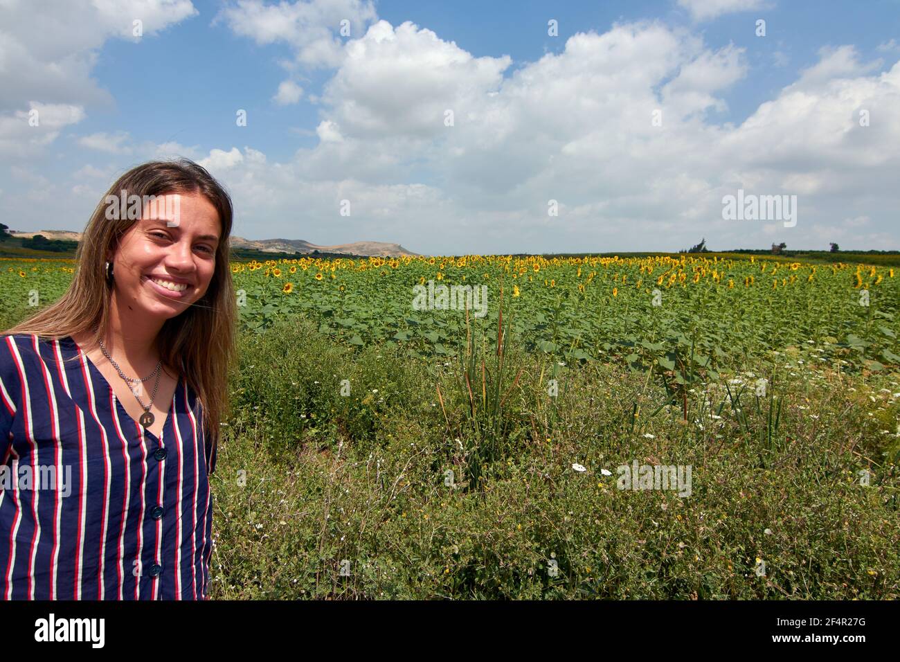 Smiling beautiful Turkish woman with a sunflower field background Stock ...
