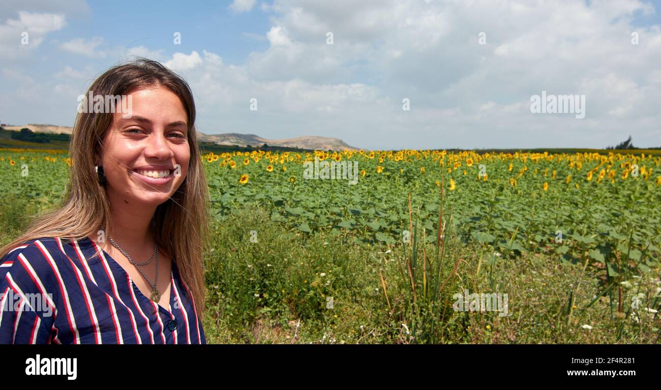 Smiling beautiful Turkish woman with a sunflower field background Stock ...