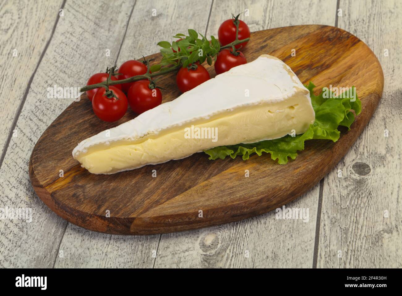 Brie cheese triangle served salad leaves Stock Photo - Alamy