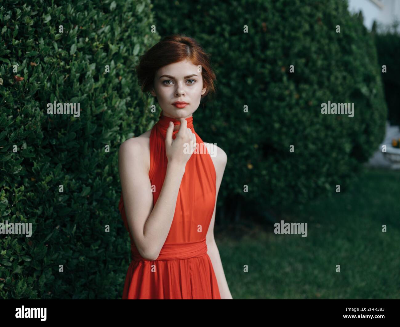 Woman in red dress luxury charm walk green bush nature gothic summer ...