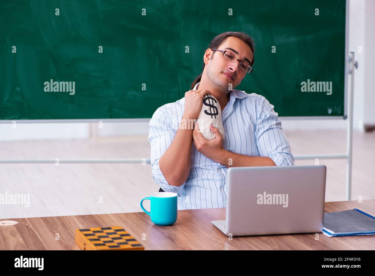 Young teacher in remuneration concept Stock Photo - Alamy