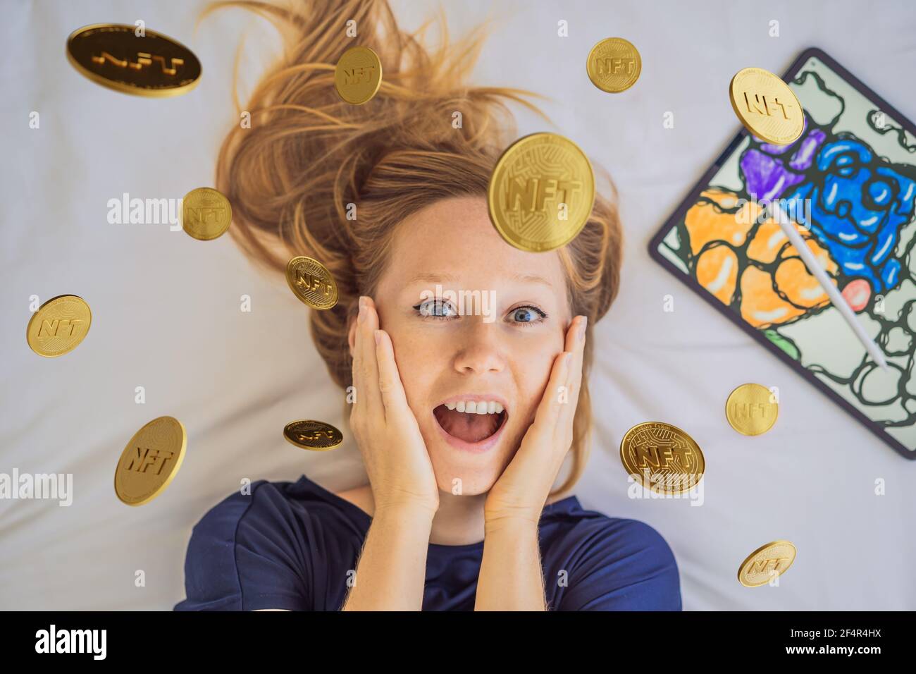 NFT Young woman, a digital artist, creates digital art on a tablet at ... NFT Young woman, a digital artist, creates digital art on a tablet at ...