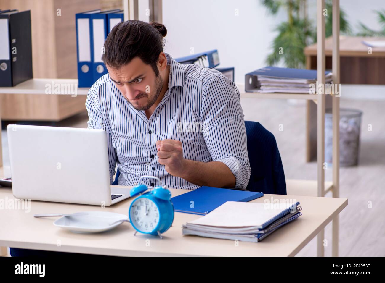 Hungry employee waiting for food in time management concept Stock Photo ...
