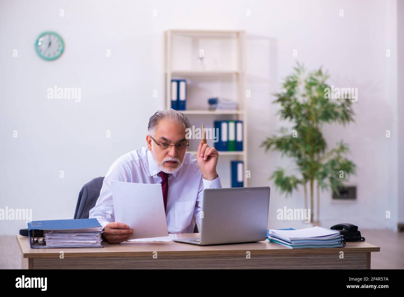 Old employee working in the office Stock Photo - Alamy