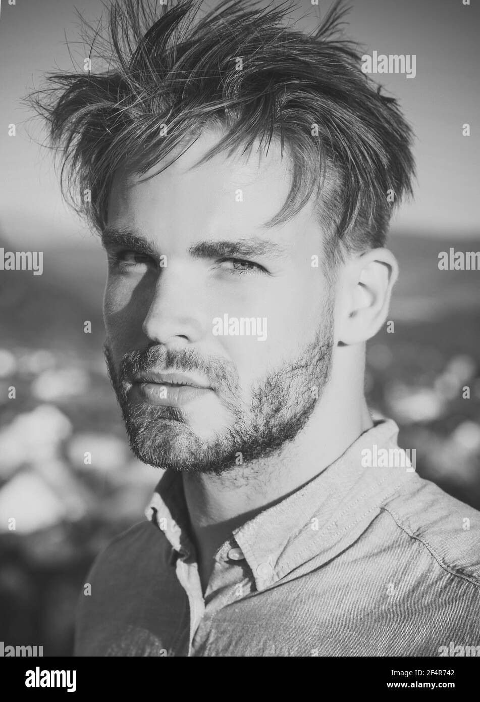 Man with serious face posing outdoor. Male beauty concept Stock Photo ...