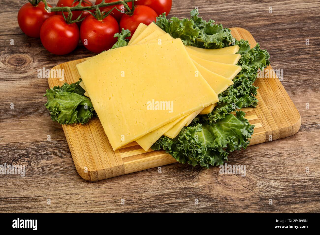 Sliced Gauda cheese snack over board Stock Photo - Alamy