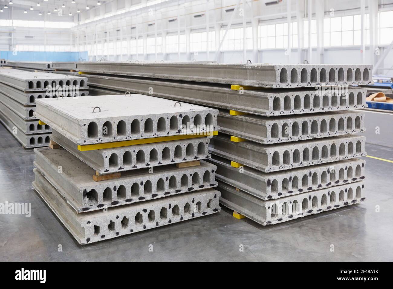Stack of precast reinforced concrete slabs in a house-building factory ...