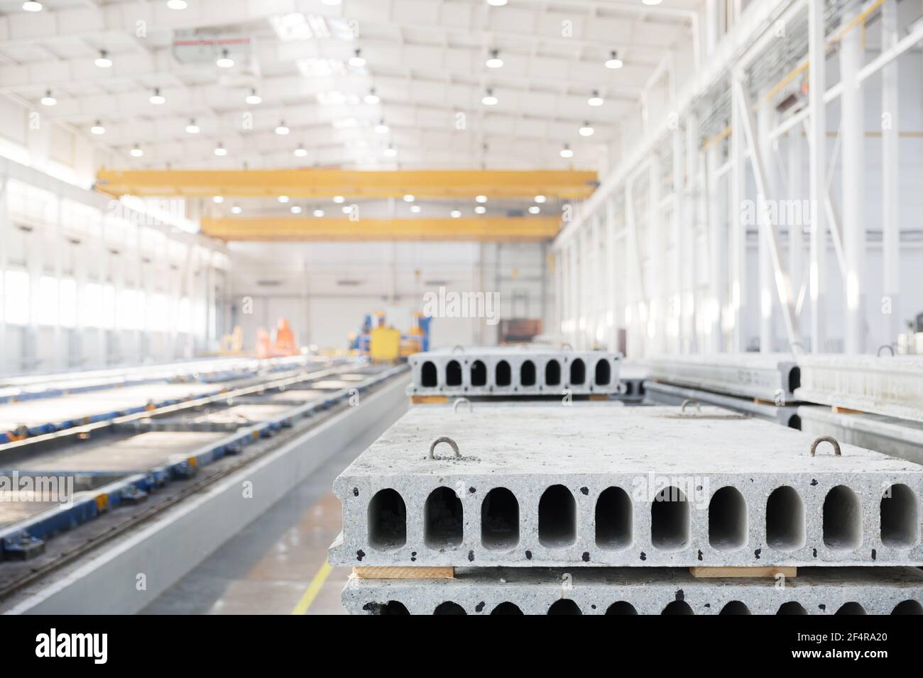 Stack of precast reinforced concrete slabs in a house-building factory ...