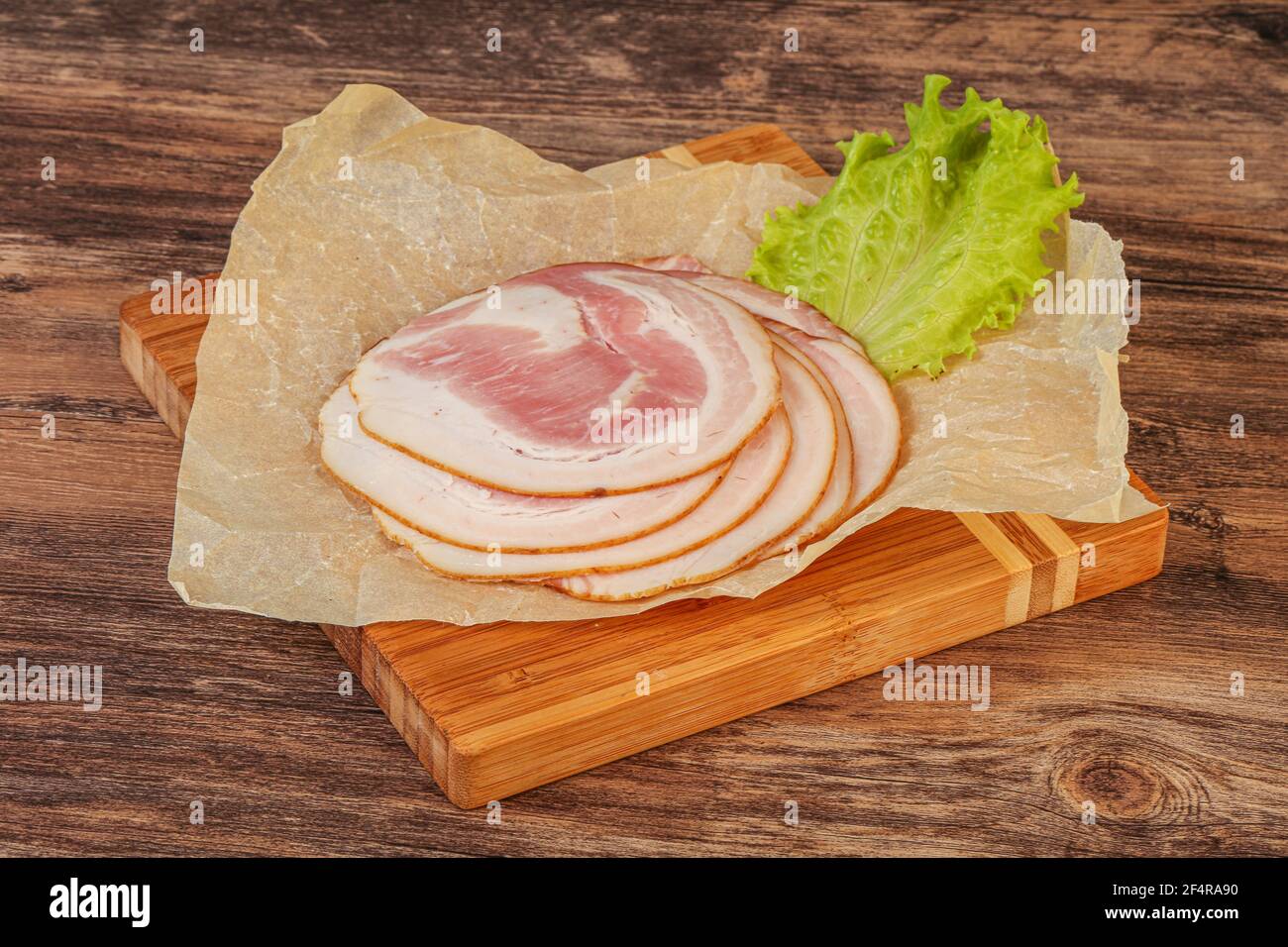 Sliced Italian Pancetta sausage over board Stock Photo - Alamy