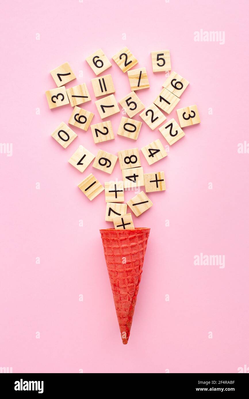Wooden plaques with numbers and signs in an ice cream cone on a color ...