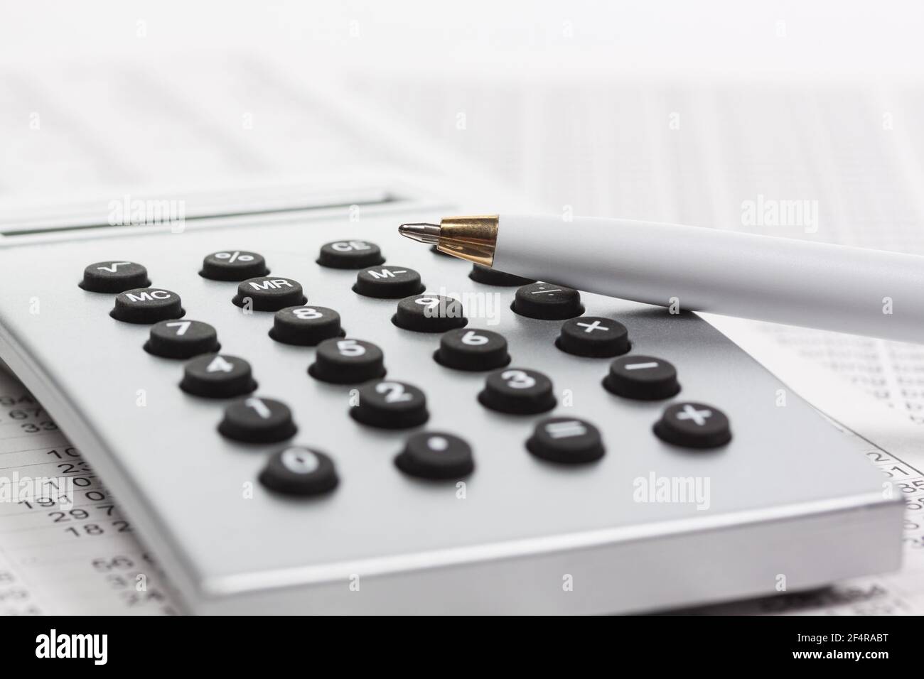 Financial accounting Pen and calculator on balance sheets Stock Photo ...