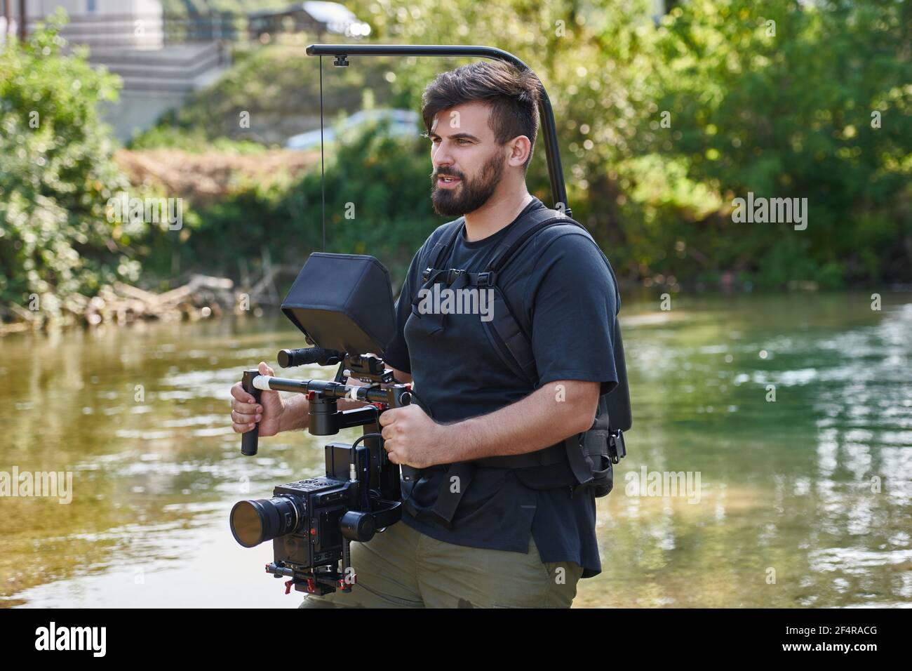 a professionally equipped cameraman shoots in the water surrounded by ...