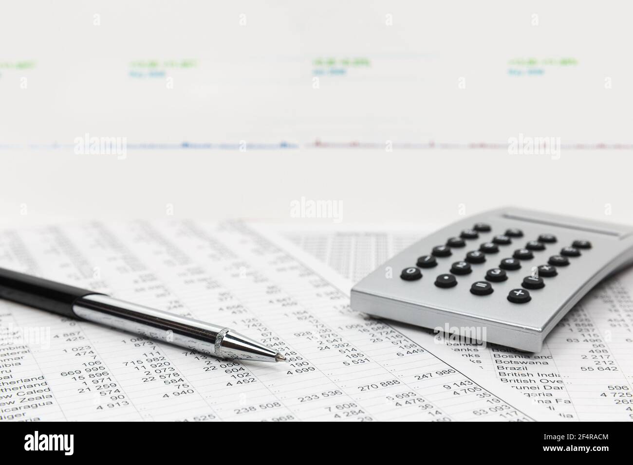 Financial accounting Pen and calculator on balance sheets Stock Photo ...
