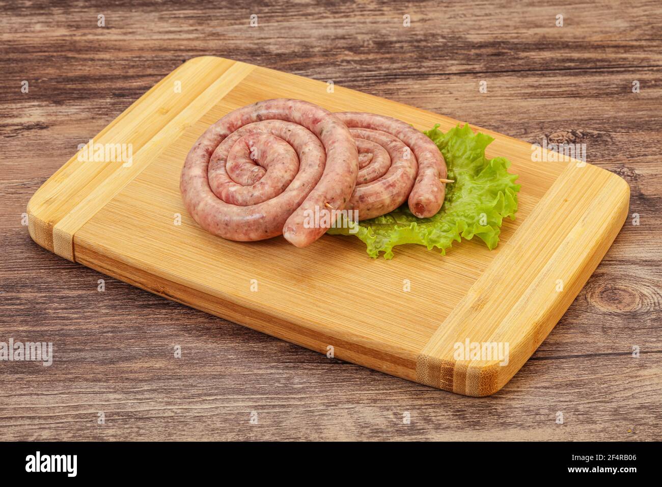 Raw pork sausage ring for grill Stock Photo - Alamy