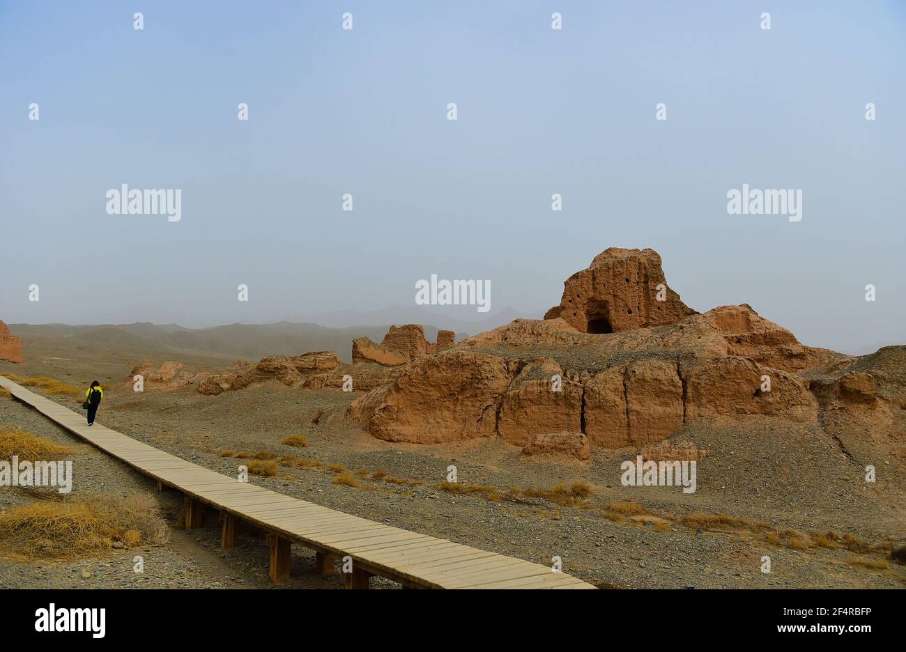 Kuqa. 22nd Mar, 2021. A tourist visits the ruins of the Subax buddhist ...