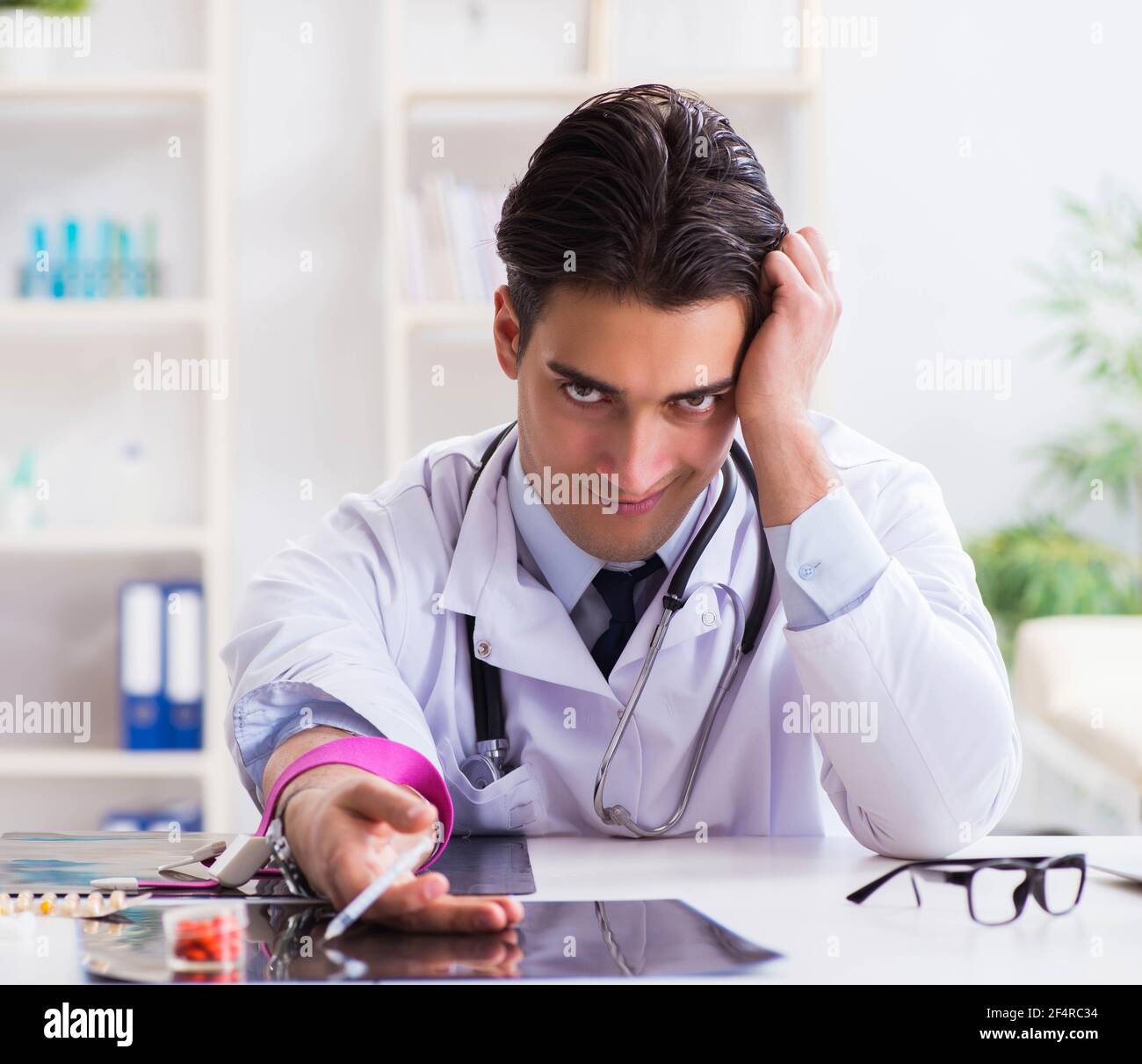 The doctor drug addict in the hospital Stock Photo - Alamy