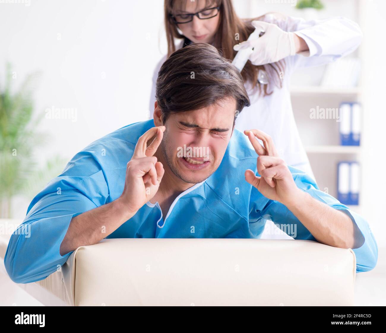 The funny man getting ready for buttocks syringe shot Stock Photo - Alamy