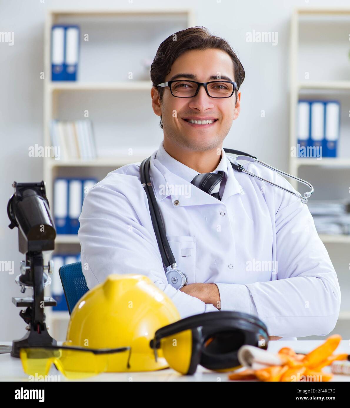 The safety doctor advising about wearing hard hat Stock Photo - Alamy