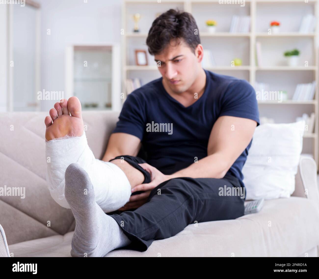 The man with broken leg recovering at home Stock Photo - Alamy