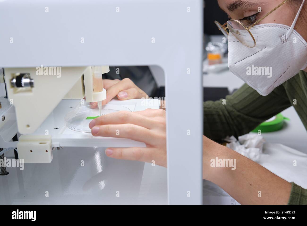 Researcher getting 3D bioprinter ready to 3D print cells onto an ...