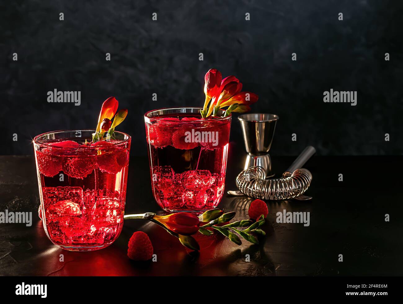 Raspberry alcoholic cocktail with liqueur, vodka, ice, and soda water ...