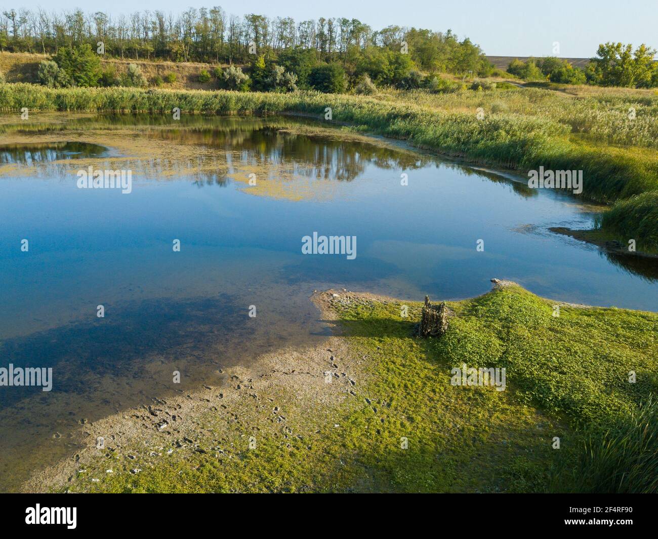 Aerial view of the countryside and a circular lake in the middle of the ...